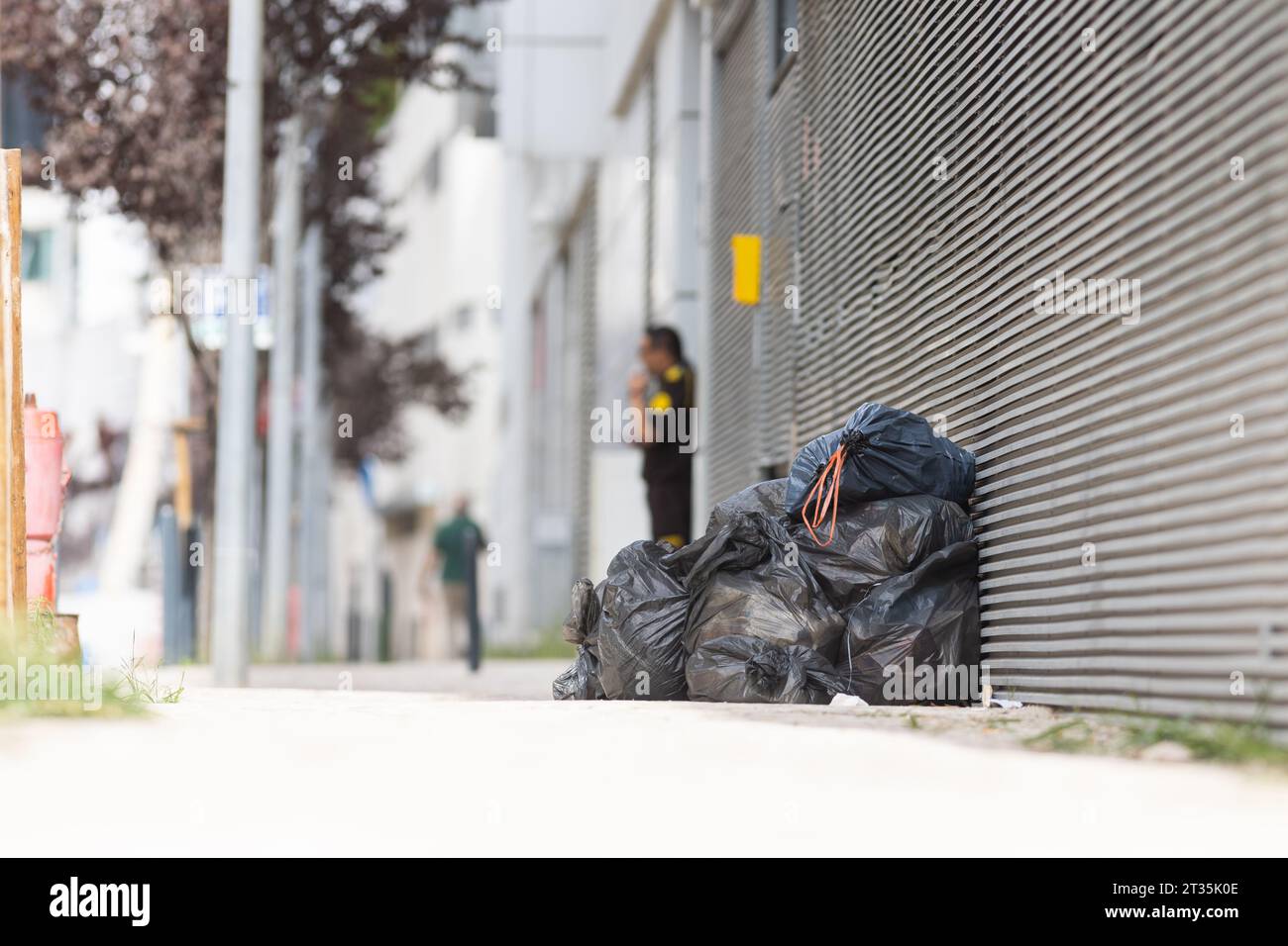Bags and trash beside a street wall - garbage on the street Stock Photo ...