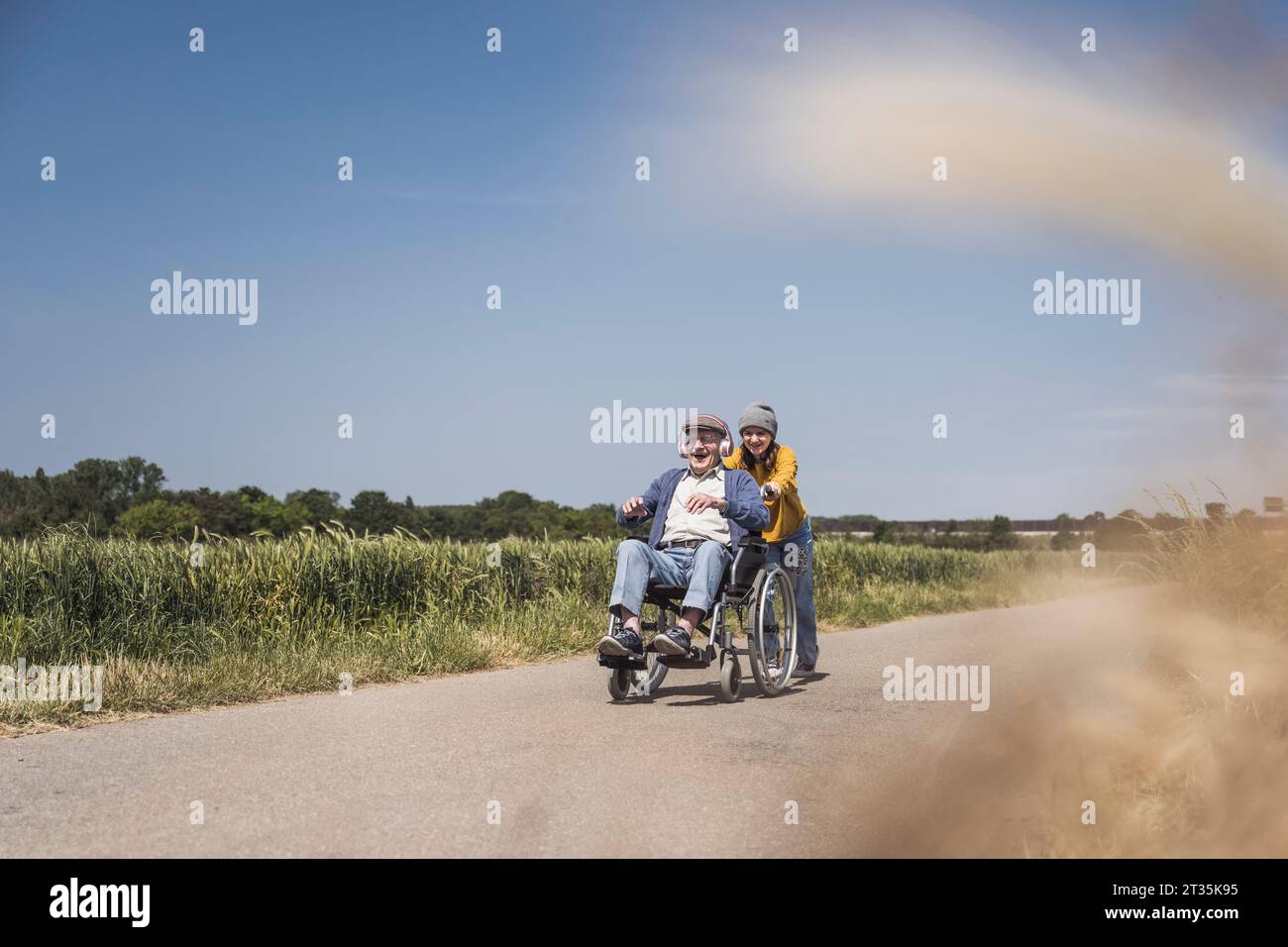 Girl pushing wheelchair hi-res stock photography and images - Alamy