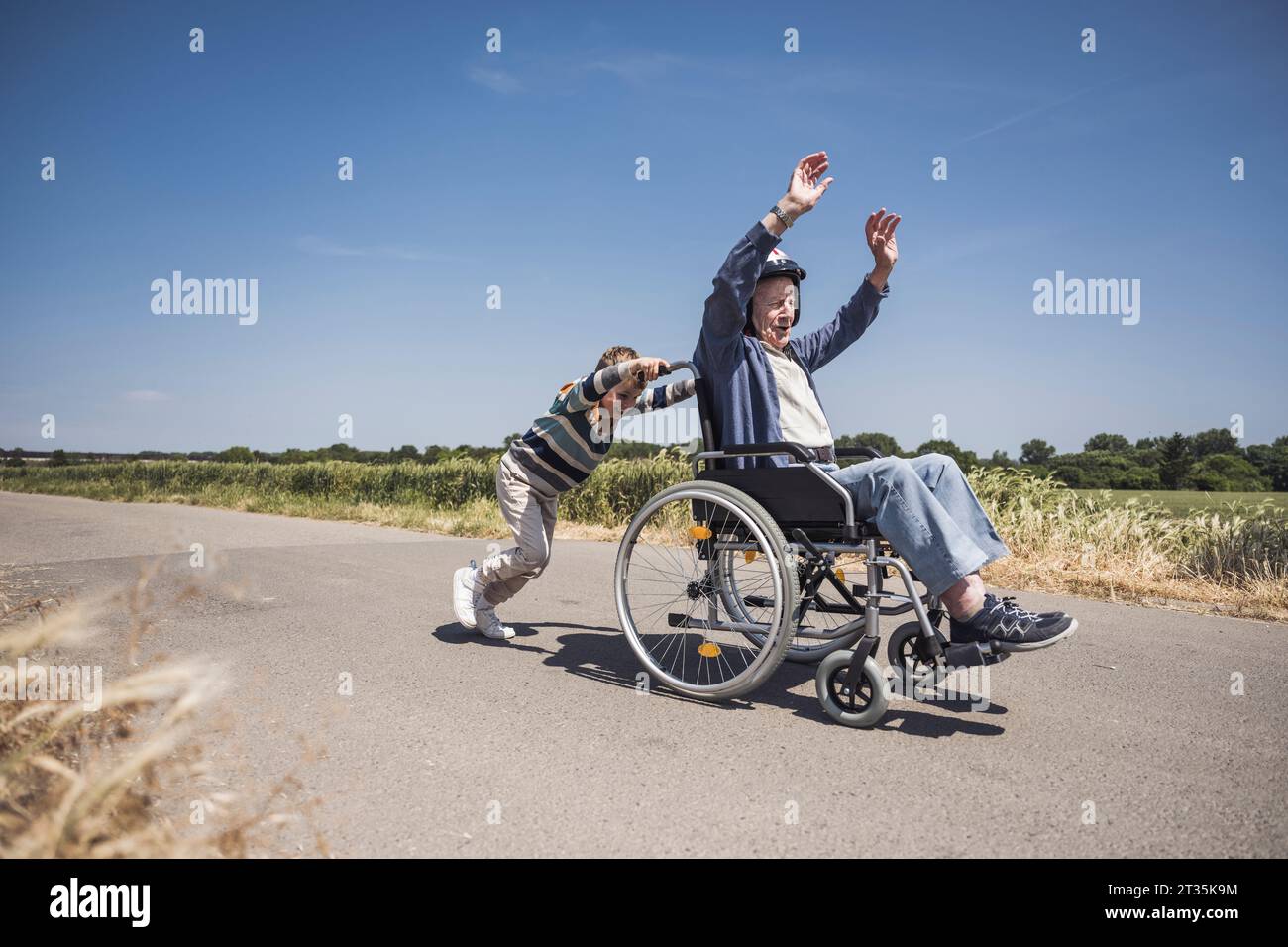 Pushing wheelchair hi-res stock photography and images - Alamy