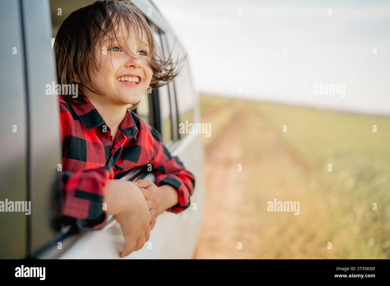Happy children looking out of window hi-res stock photography and ...