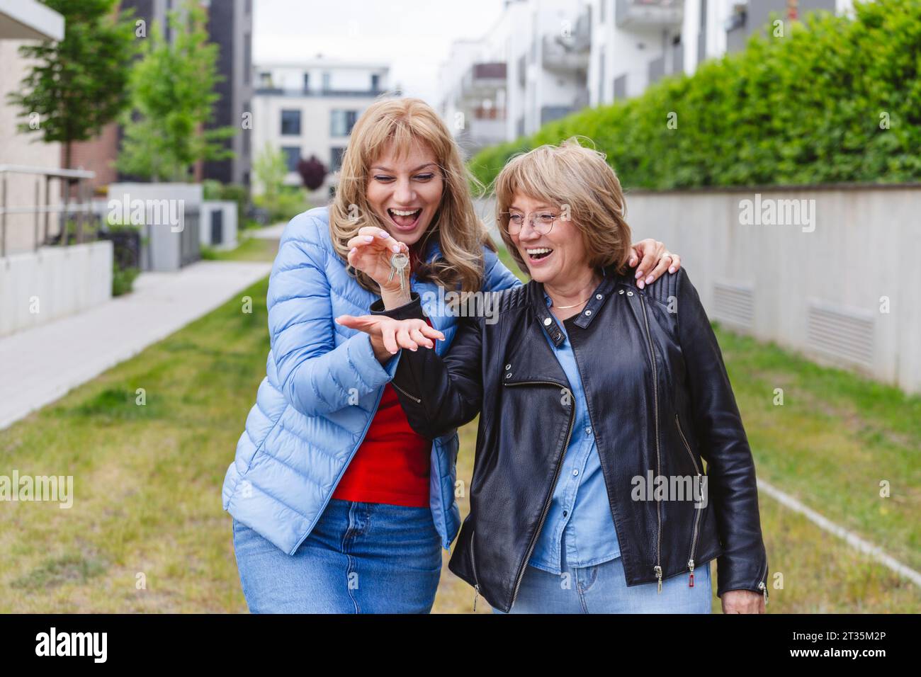 Happy mother giving key to daughter Stock Photo - Alamy