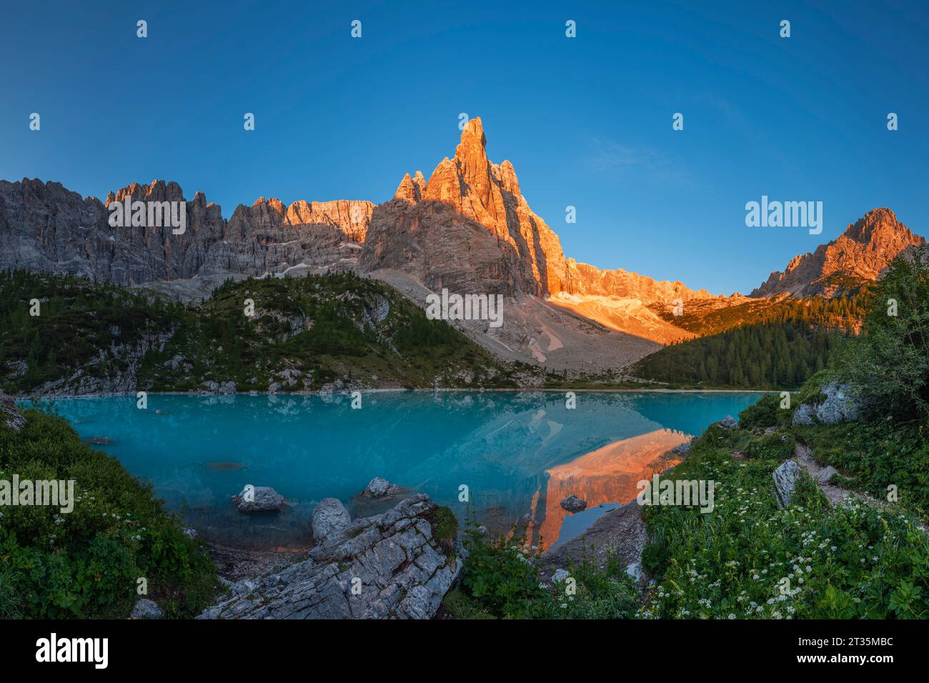 Italy, Veneto, Lake Sorapiss and Dito di Dio peak at springtime dawn ...