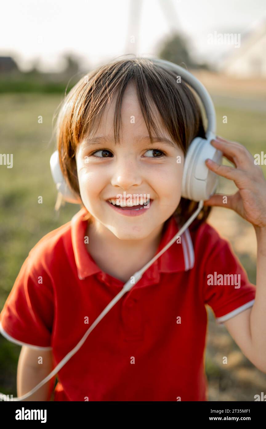 Boy listening with headphones hi-res stock photography and images - Alamy