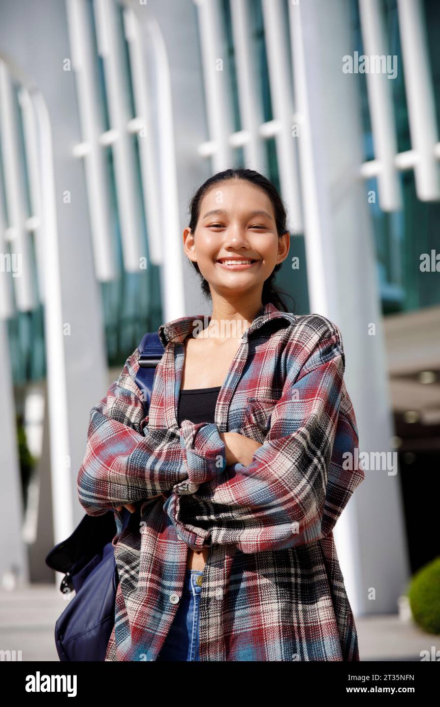 Smiling student standing arms hi-res stock photography and images - Alamy