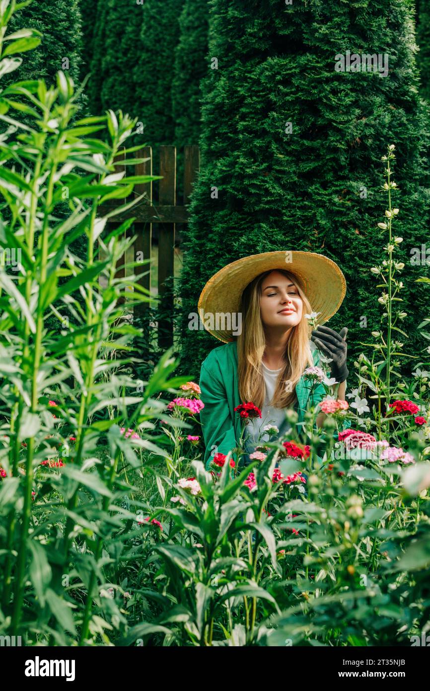Woman smelling flowers in hi-res stock photography and images - Alamy