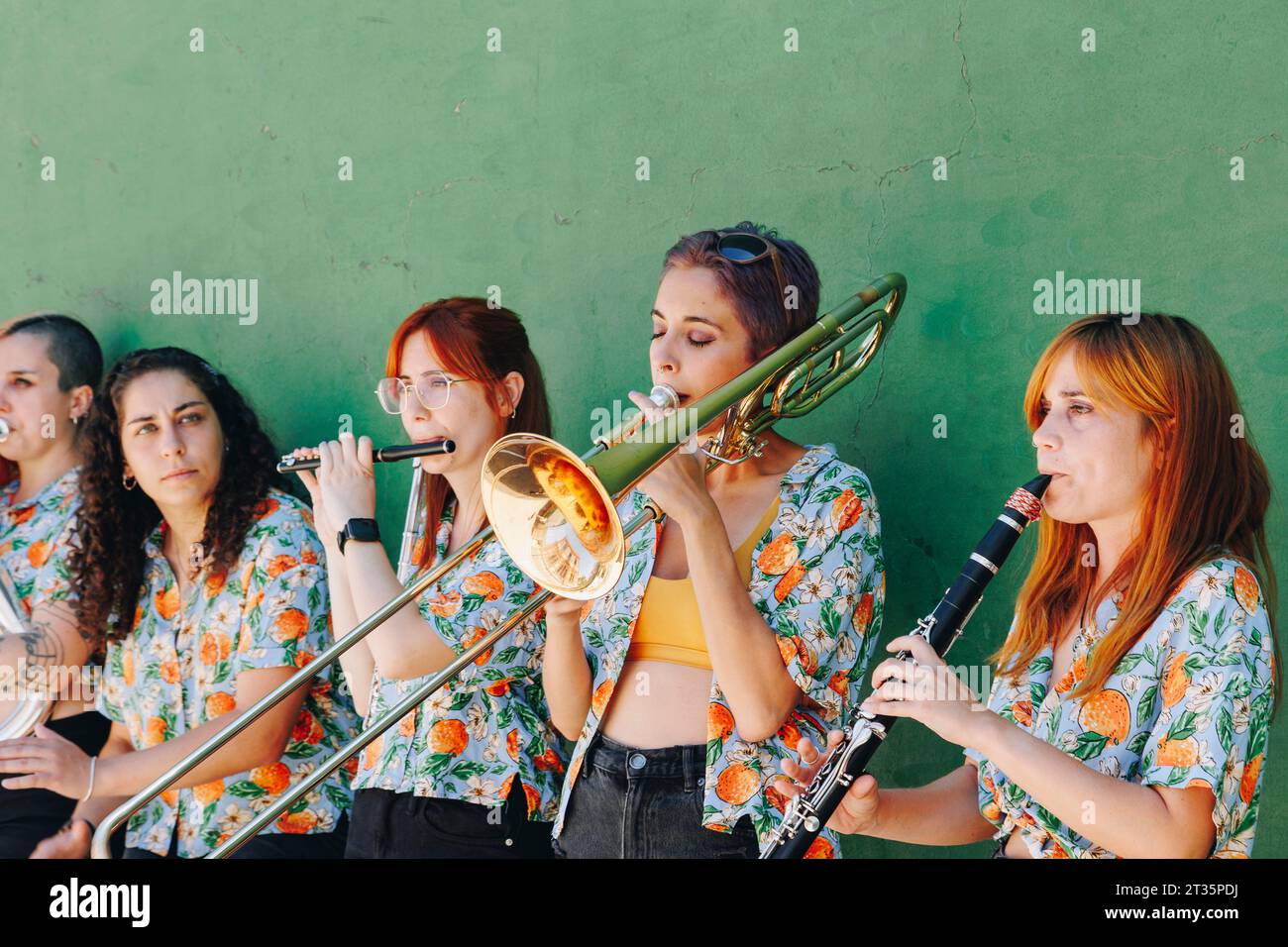 Women practicing musical instruments near wall Stock Photo - Alamy