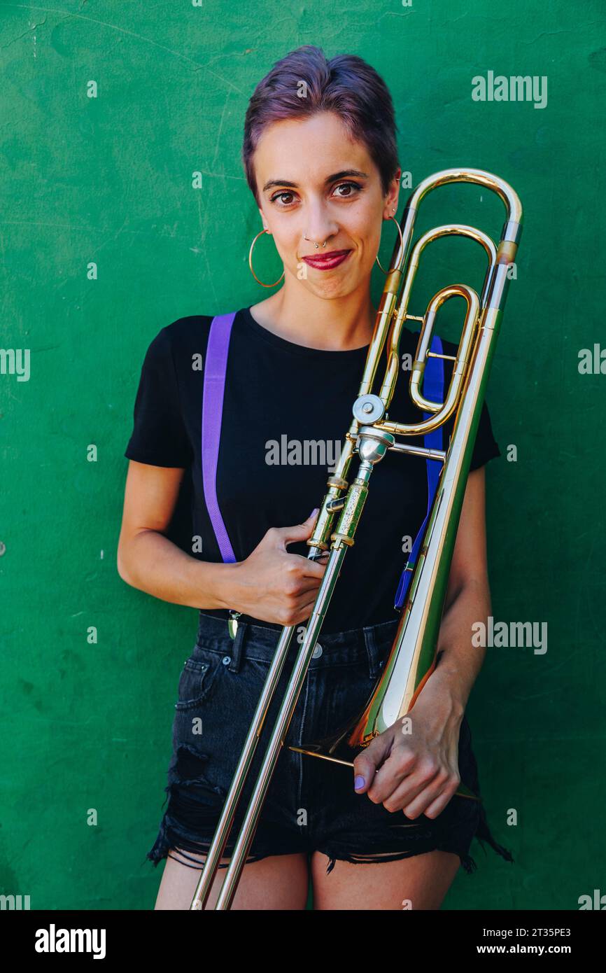 Musician holding trombone hi-res stock photography and images - Alamy