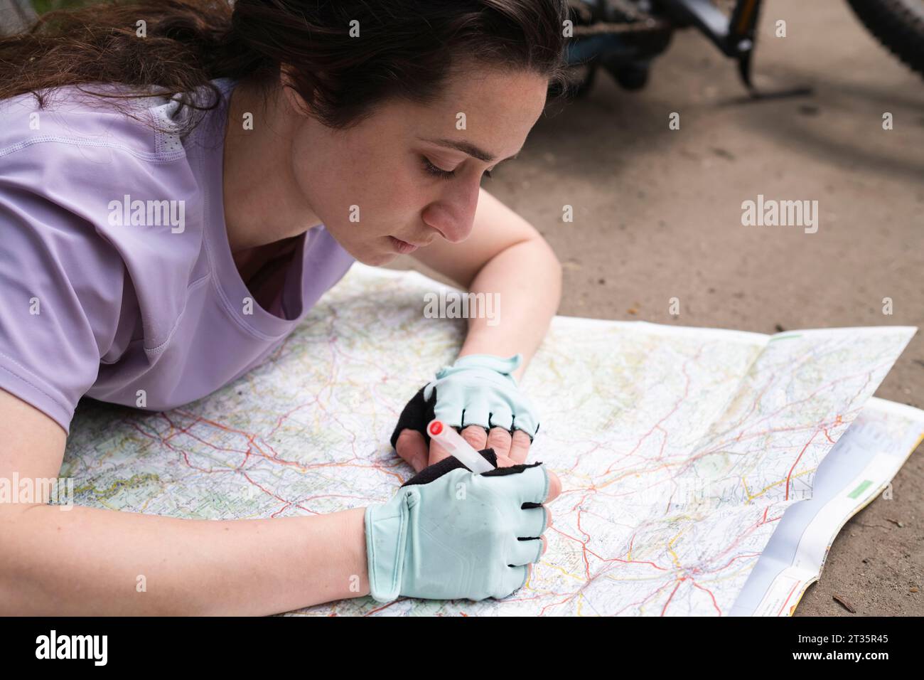 Young woman reading map on road Stock Photo - Alamy
