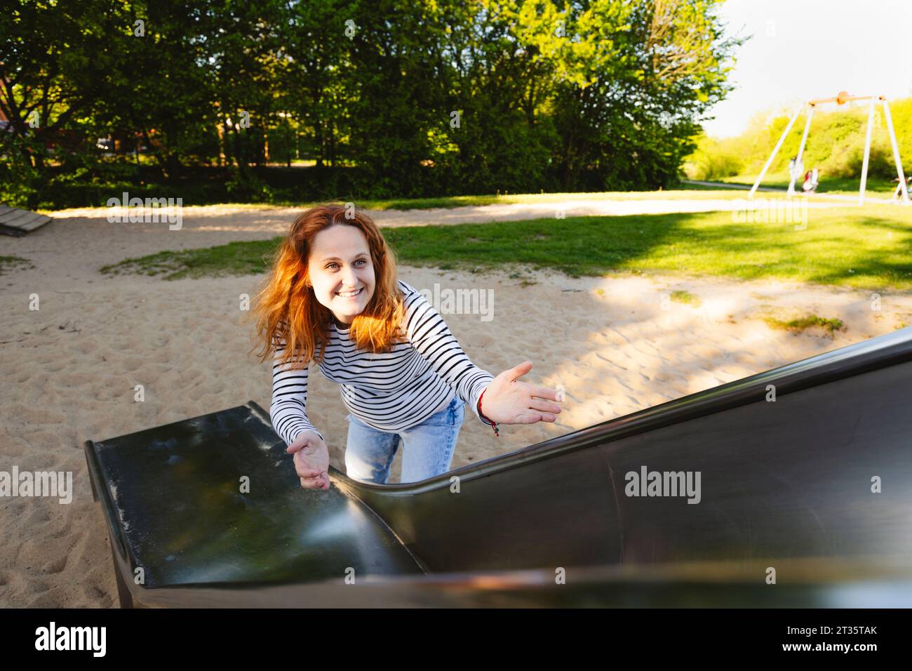 Woman standing near playground hi-res stock photography and images - Alamy