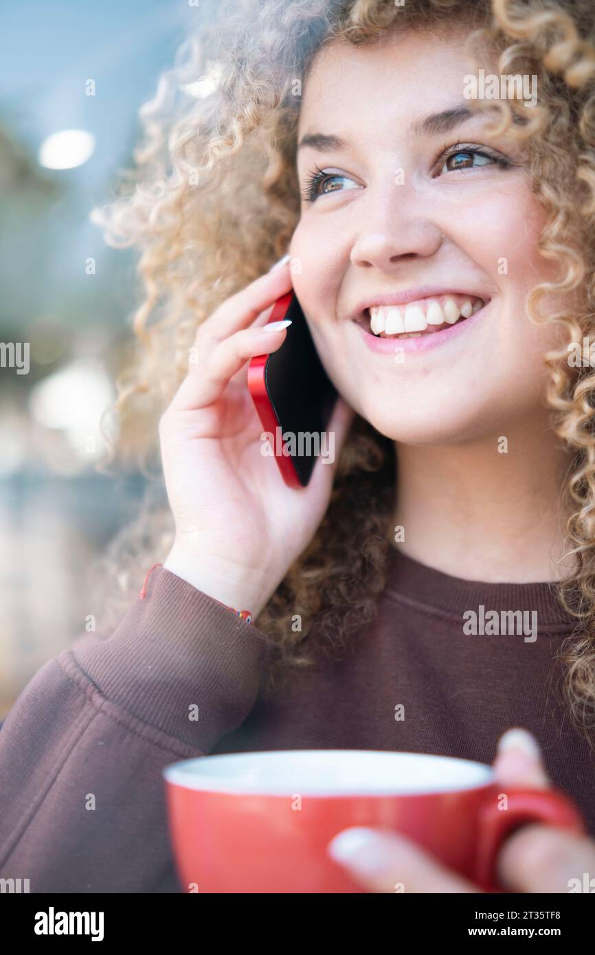 Young curly hair woman talking hi-res stock photography and images - Alamy