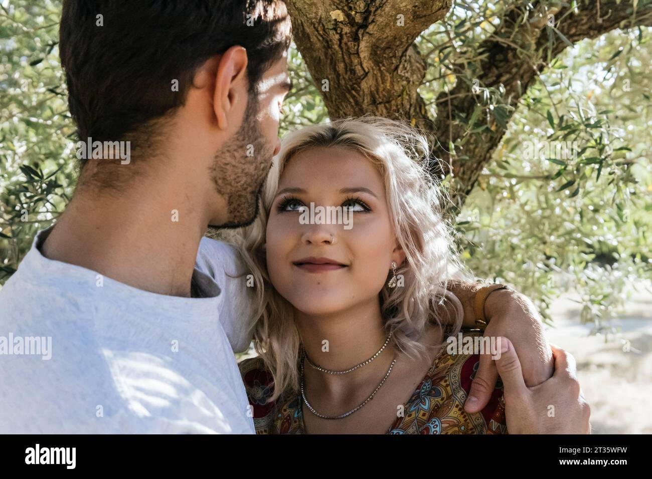 Smiling couple staring each other under tree in park Stock Photo - Alamy Smiling couple staring each other under tree in park Stock Photo - Alamy