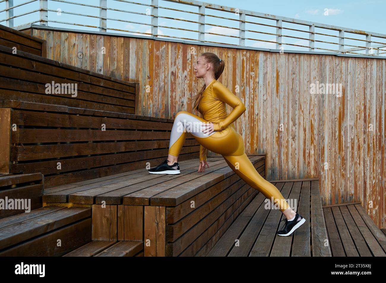 Woman doing stretching exercise on steps Stock Photo - Alamy