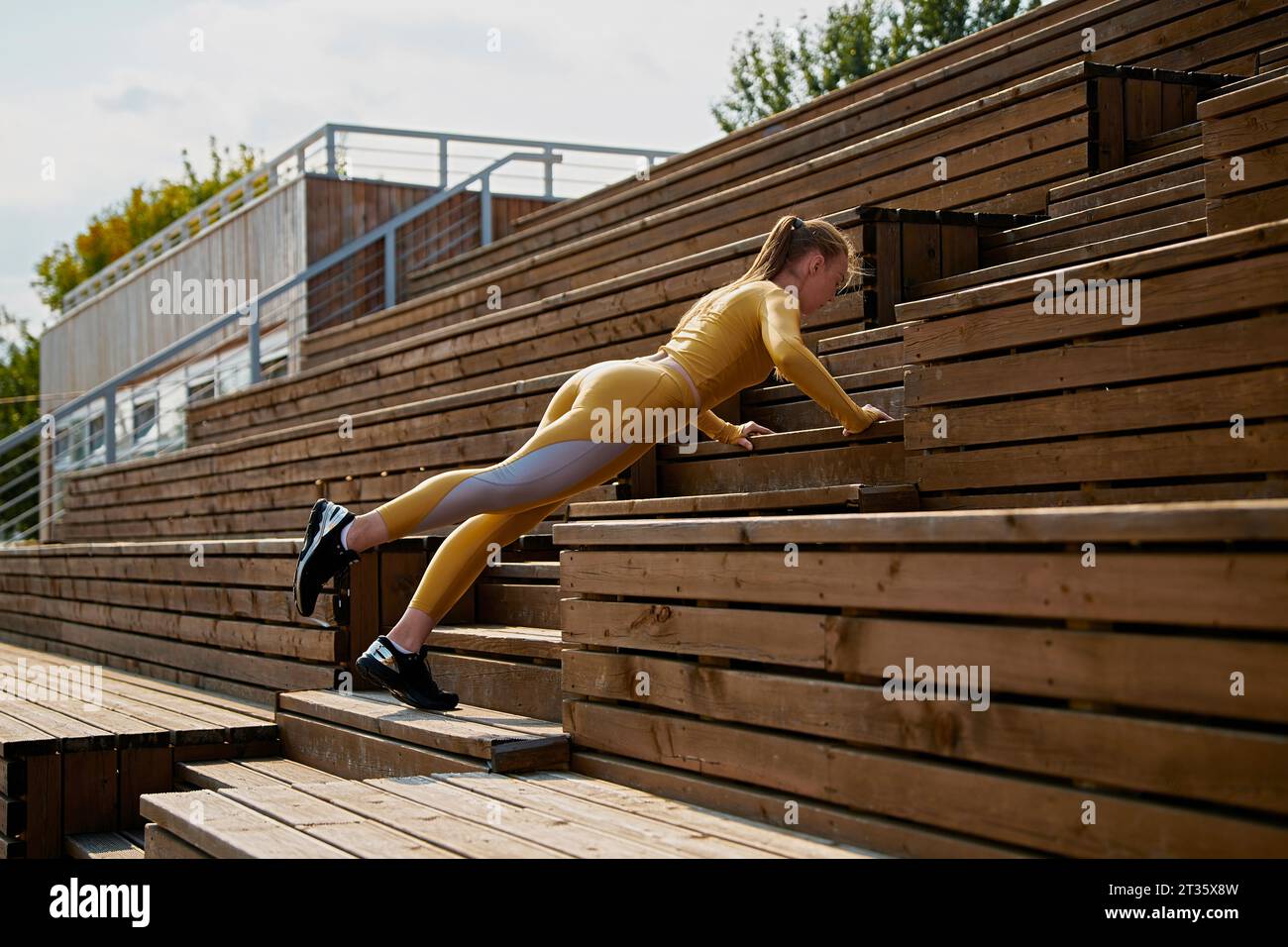 Woman doing push-ups on steps Stock Photo - Alamy