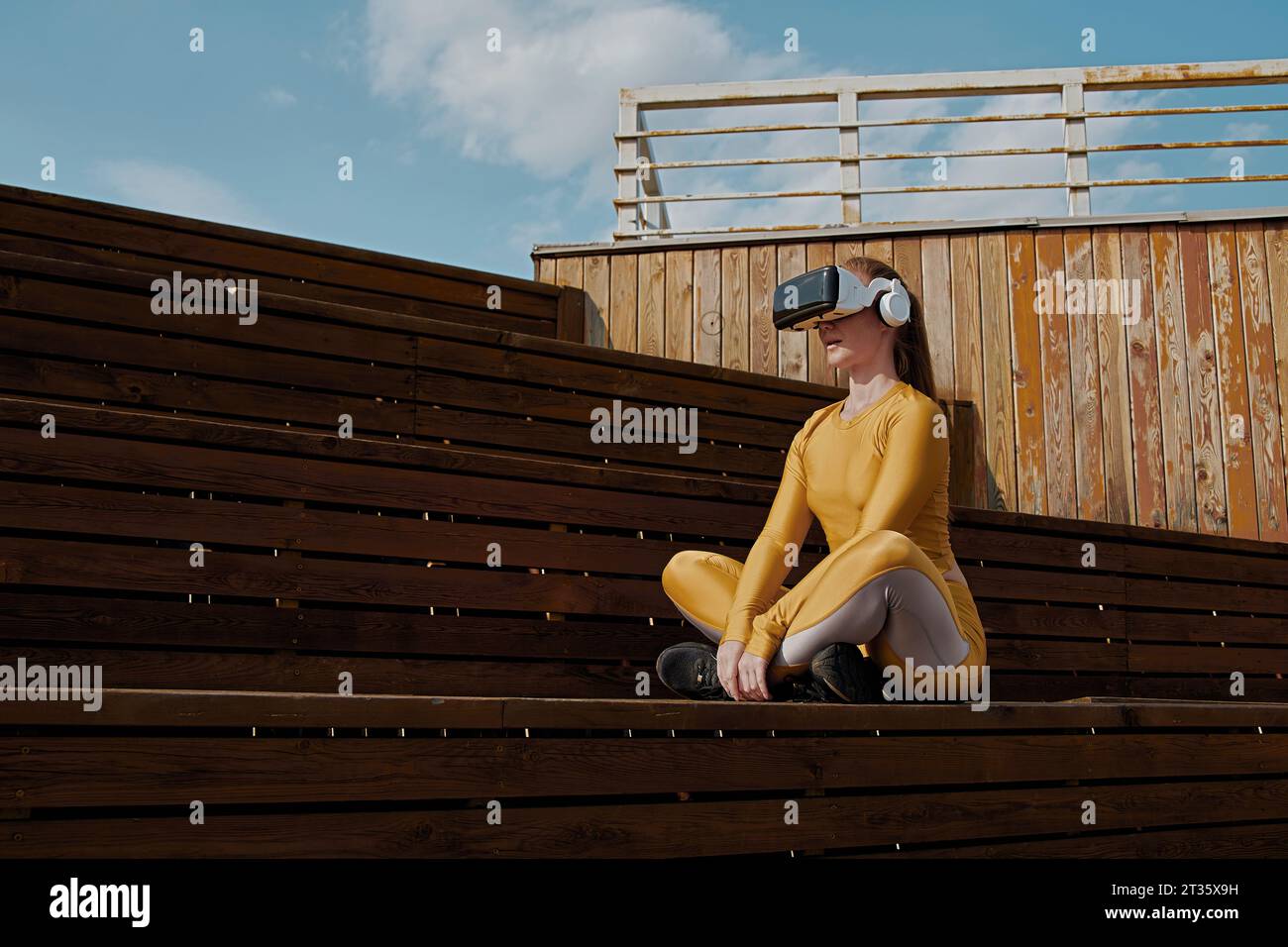Woman wearing virtual reality simulator on steps Stock Photo - Alamy