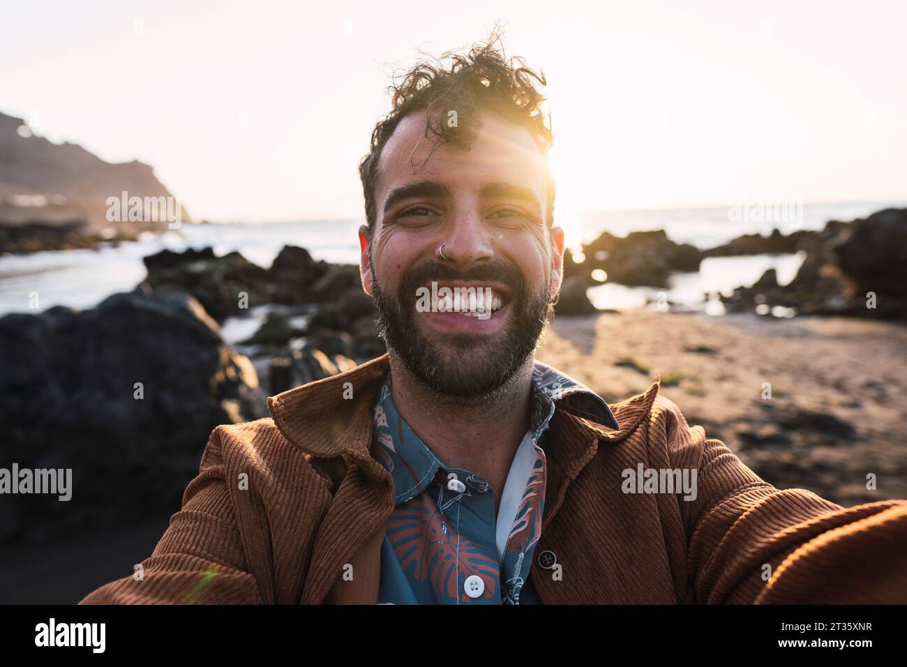 Happy man taking selfie at sunset Stock Photo - Alamy
