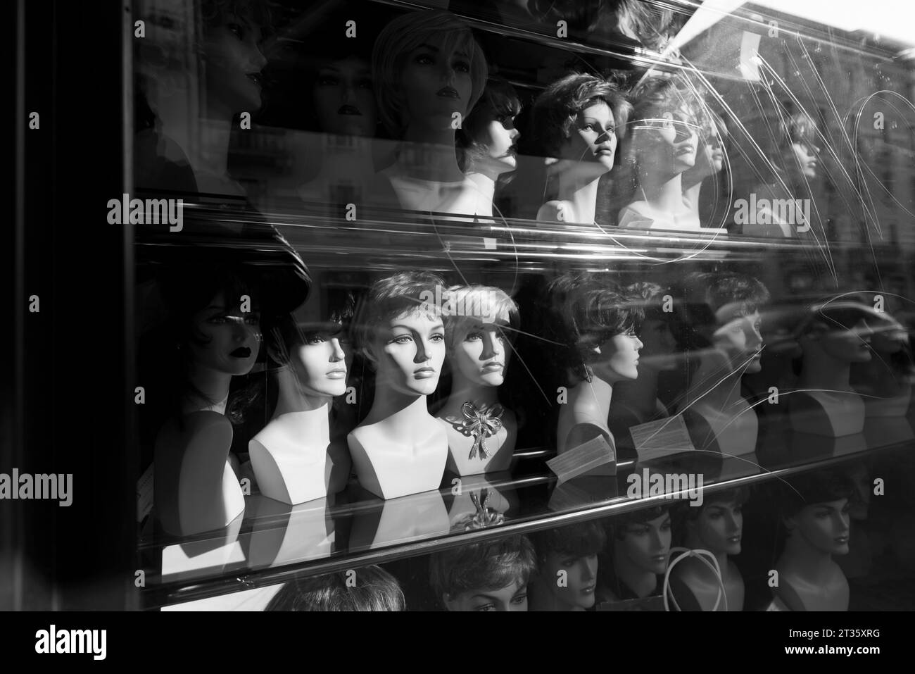 Heads shop window Stock Photo - Alamy