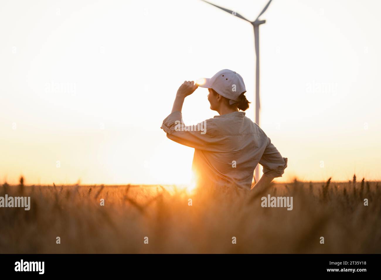 Farmer holding cap standing amidst crops in wheat field Stock Photo - Alamy