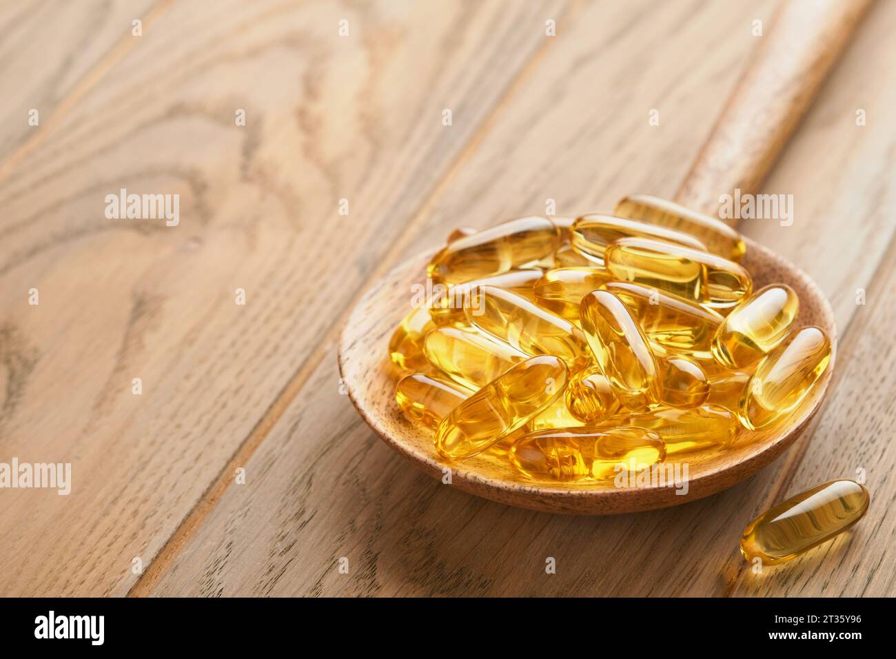 Close up capsules with Vitamin D, E or Omega 3,6,9 fatty acids in ...