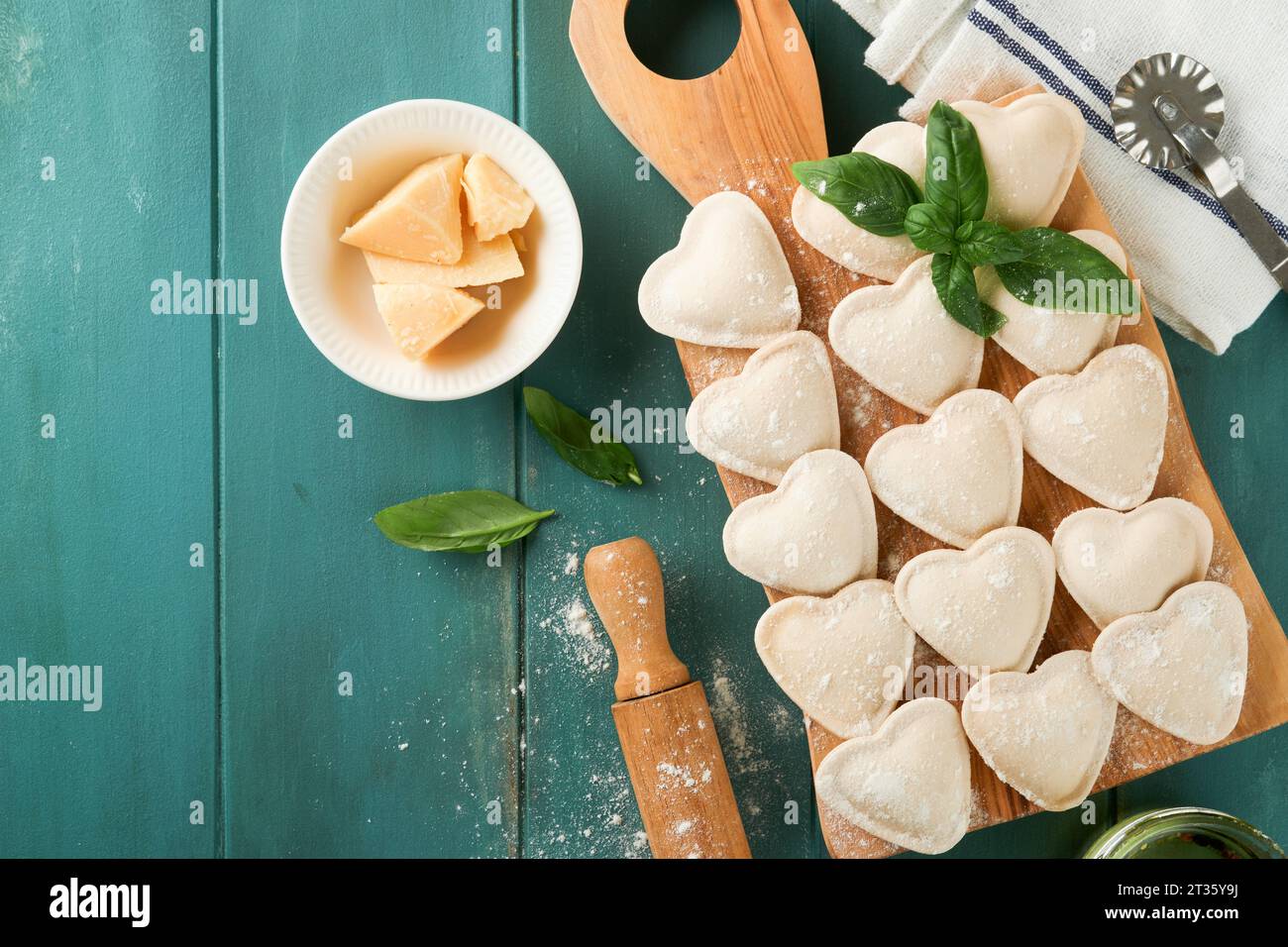 Italian ravioli pasta in heart shape.Tasty raw ravioli with flour and ...