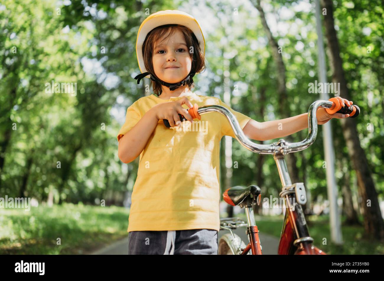 Boy standing with bicycle hi-res stock photography and images - Alamy
