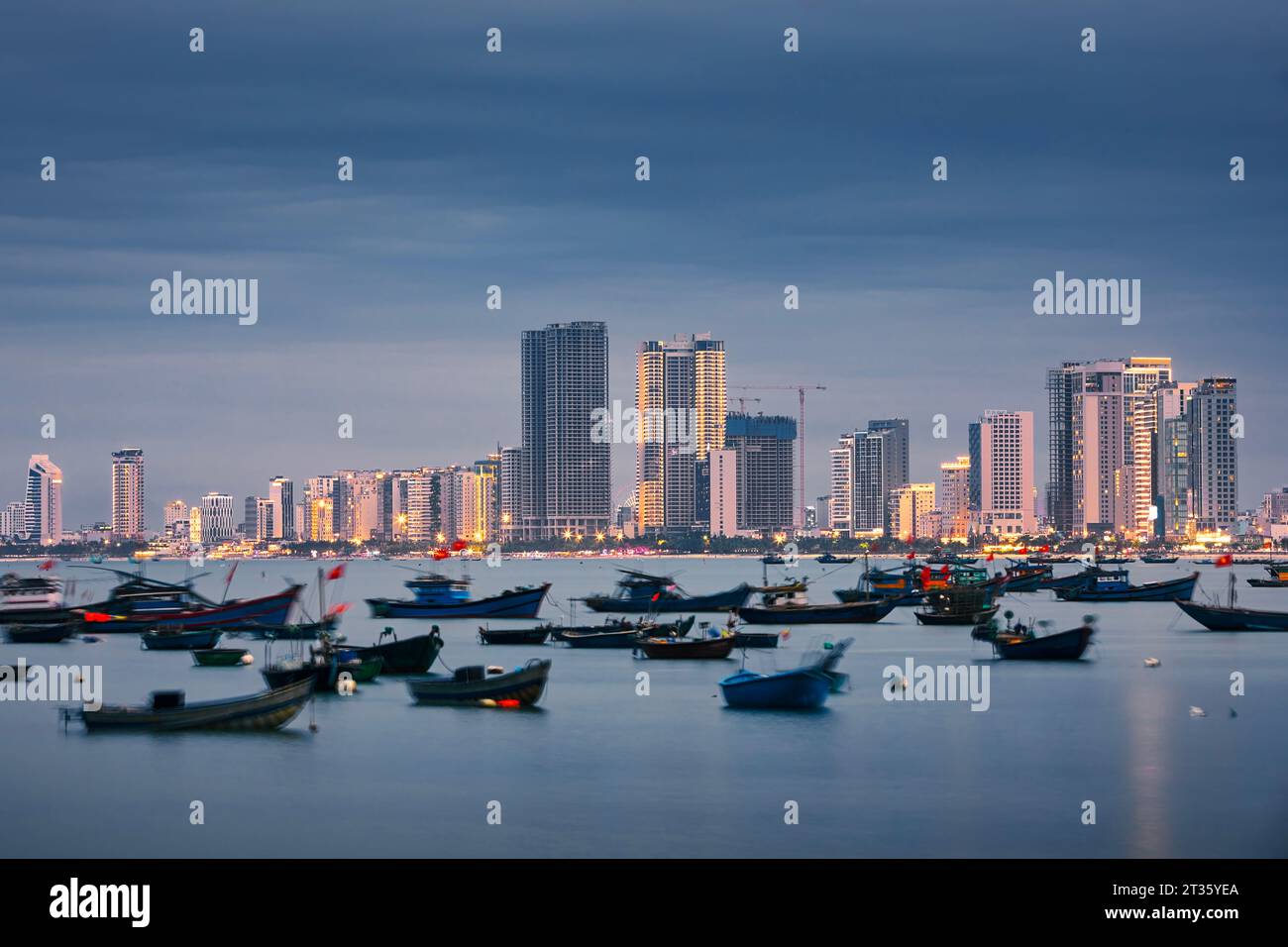 Da Nang cityscape at twilight. Fishing boat moored in port against ...