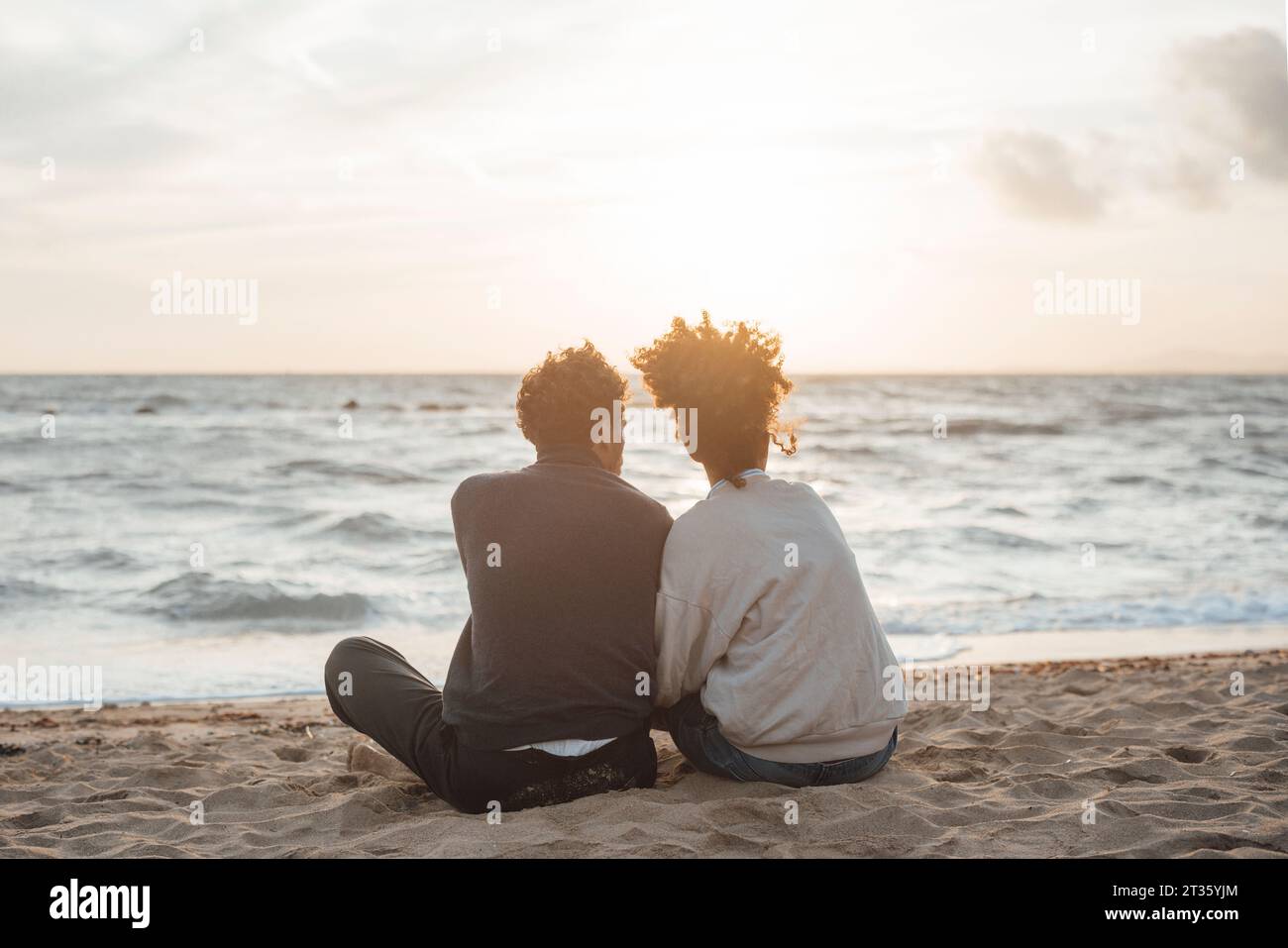 Loving couple sitting on hi-res stock photography and images - Alamy
