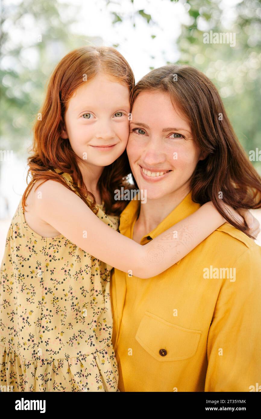 Happy daughter hugging mother in park Stock Photo - Alamy
