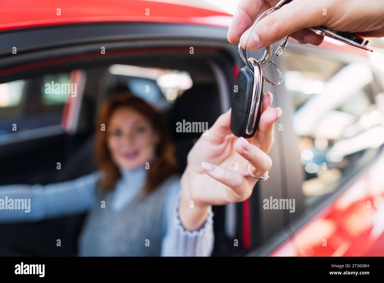 Woman taking car keys from man Stock Photo - Alamy