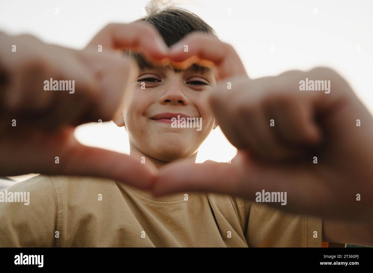 Smiling boy making heart hi-res stock photography and images - Alamy