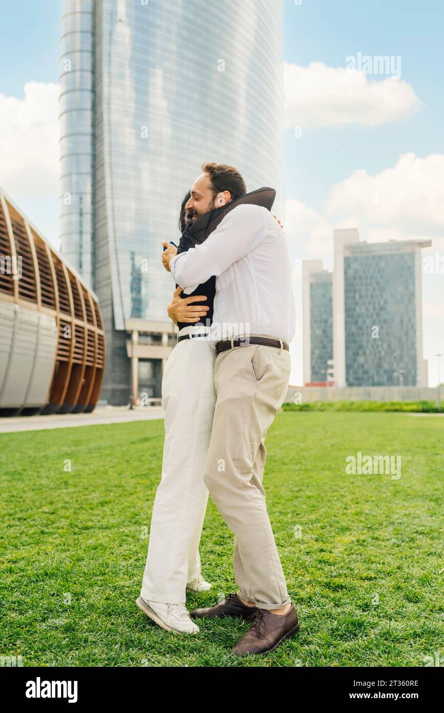 Loving couple hugging each other in front of buildings Stock Photo - Alamy
