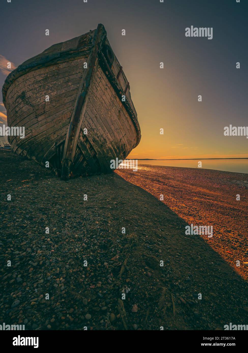 Wooden boat stranded on the beach Stock Photo - Alamy