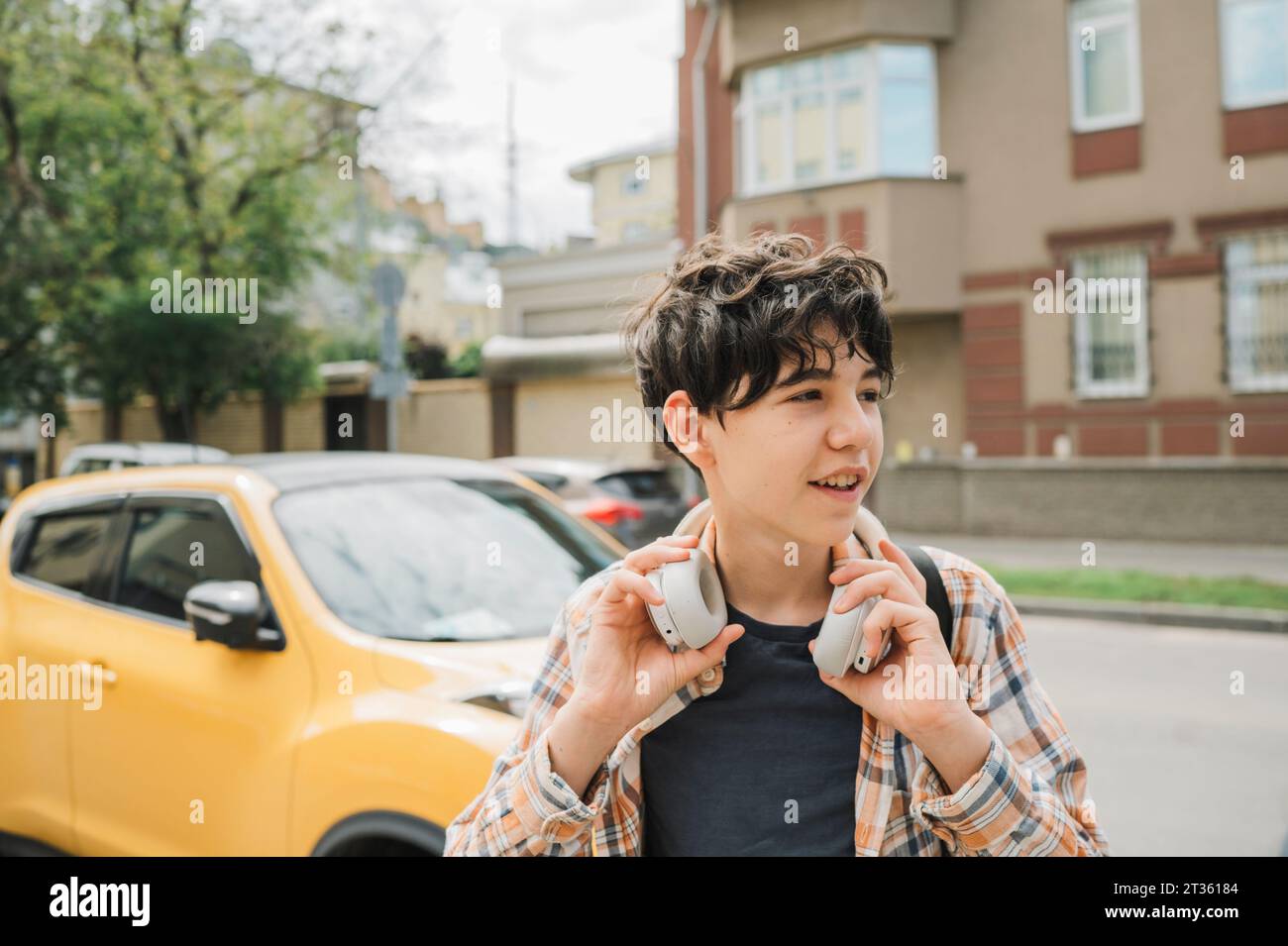 Contemplative boy walking in city Stock Photo - Alamy