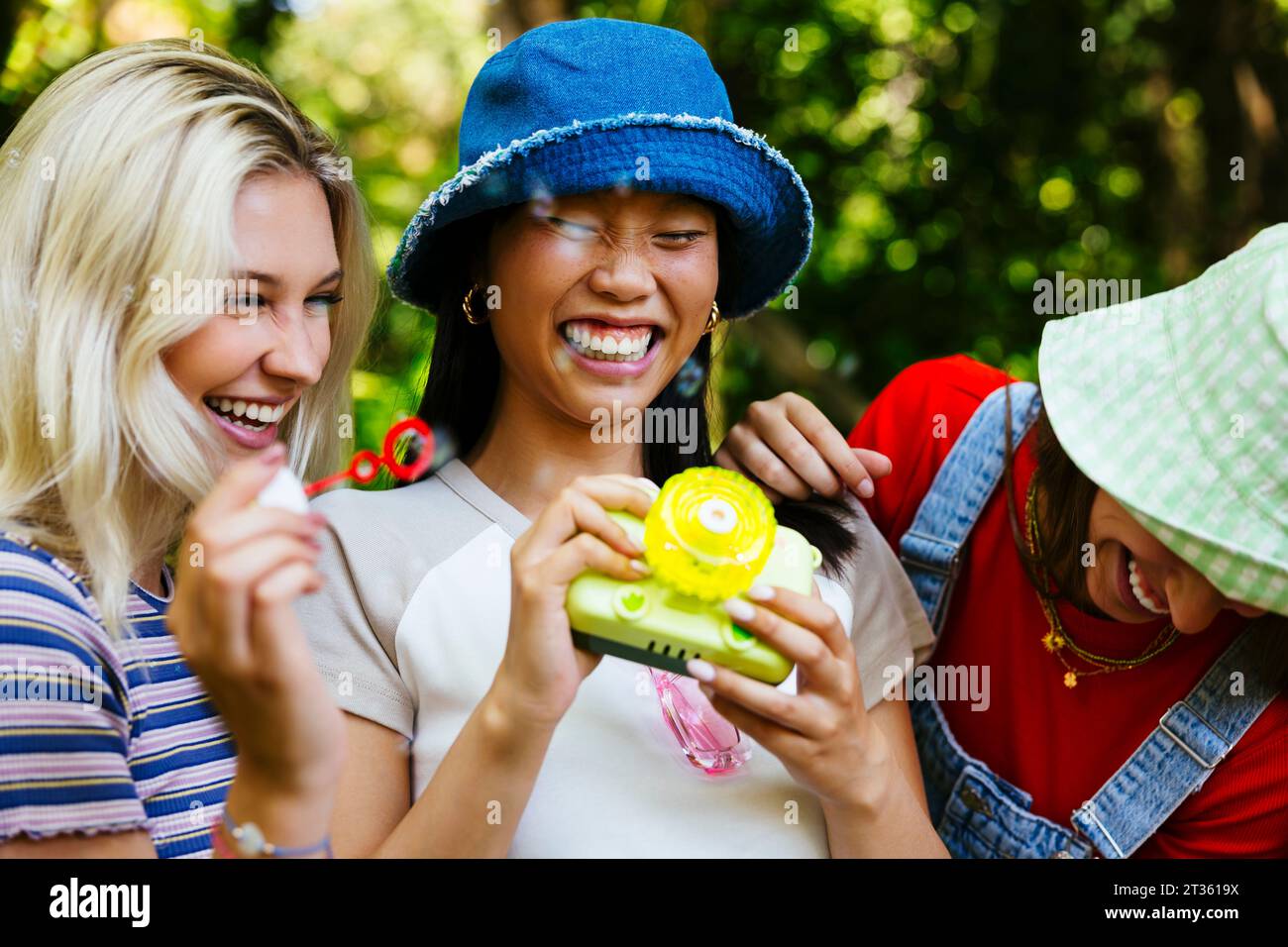 Smiling friends having fun in garden Stock Photo - Alamy