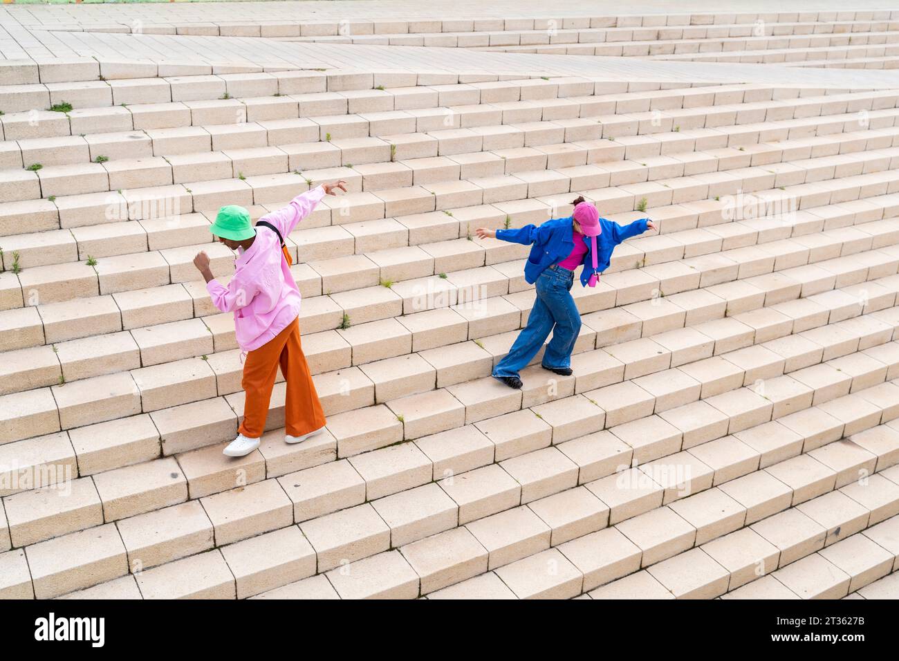 Carefree multiracial couple dancing on staircase Stock Photo - Alamy