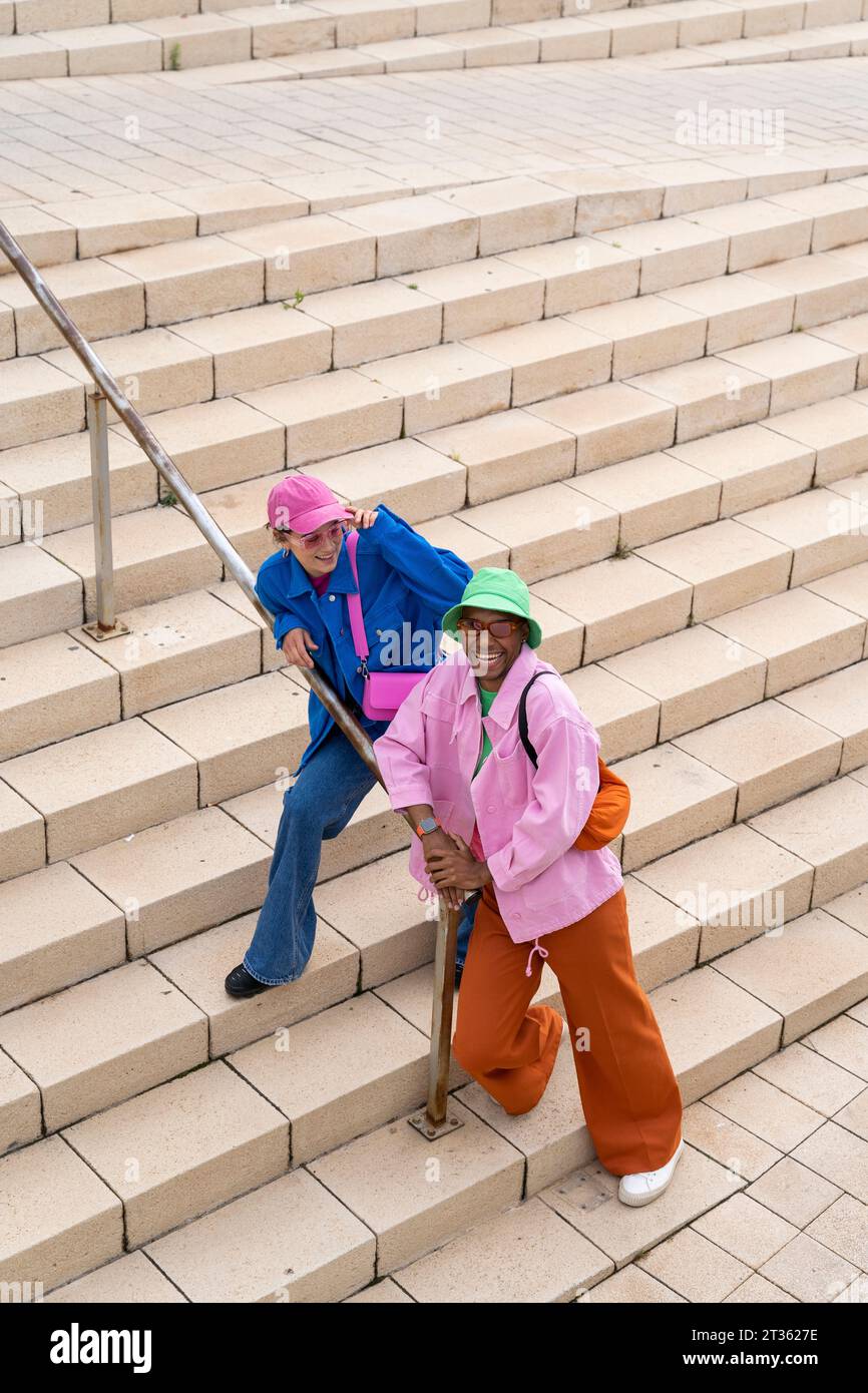 Happy couple enjoying near staircase railing Stock Photo - Alamy