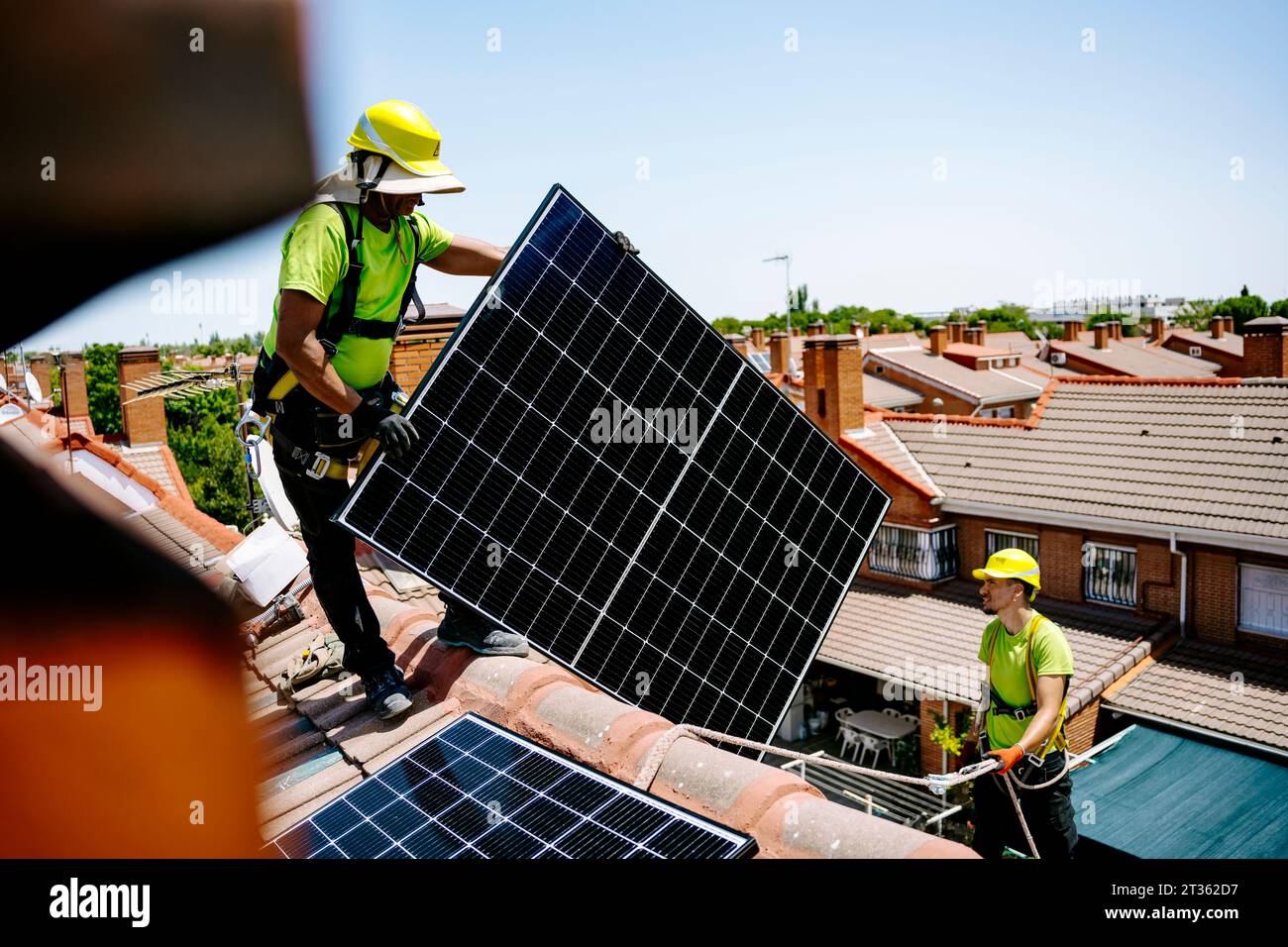Engineers installing solar panel on house roof Stock Photo - Alamy