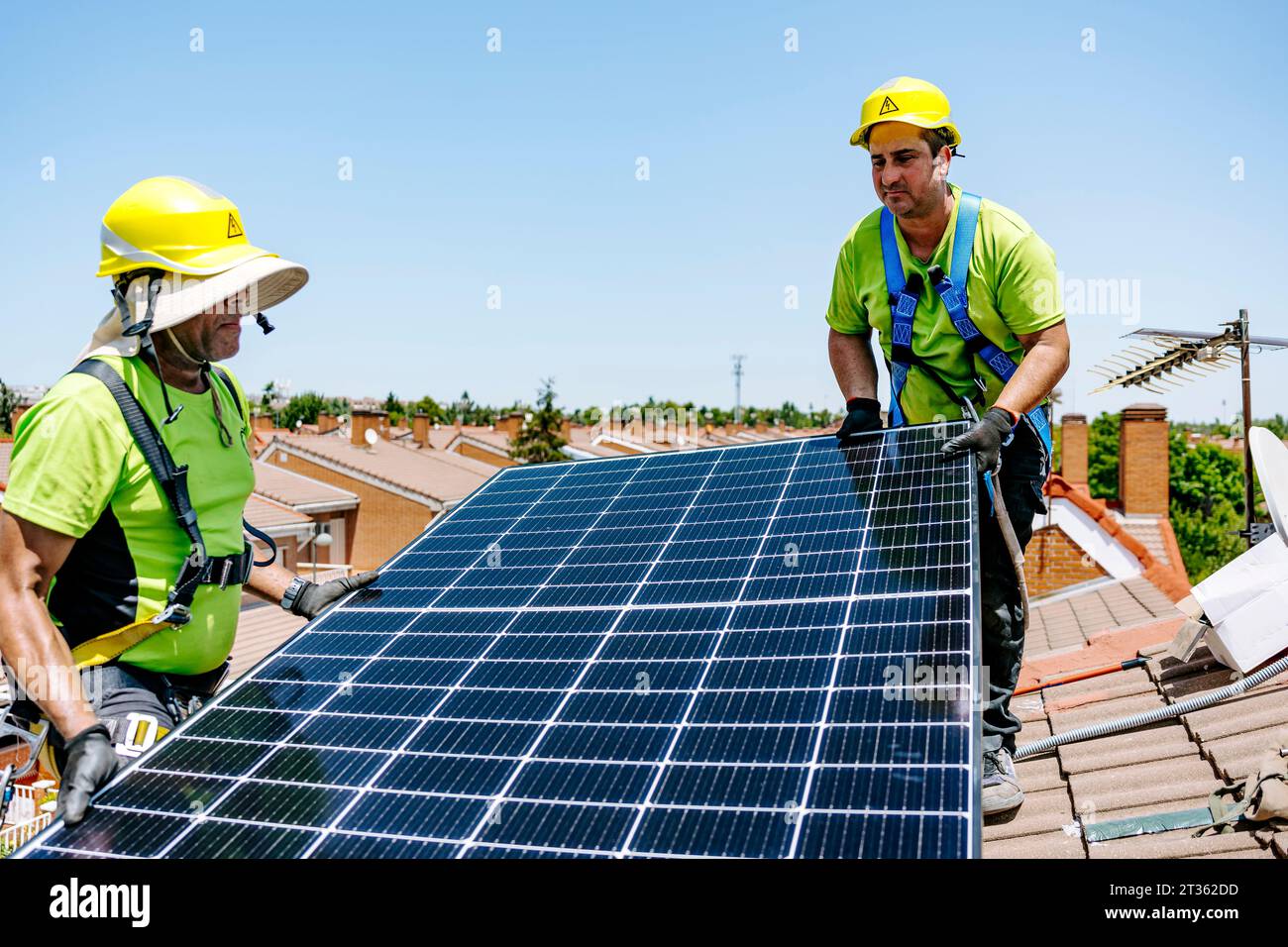 Engineers installing solar panels together on sunny day Stock Photo - Alamy