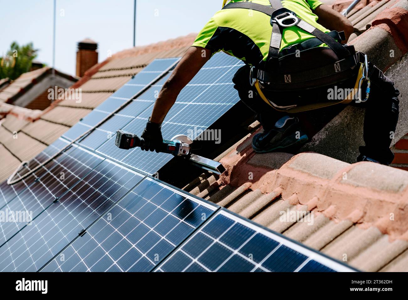 Engineer with hand tool installing solar panel on sunny day Stock Photo ...