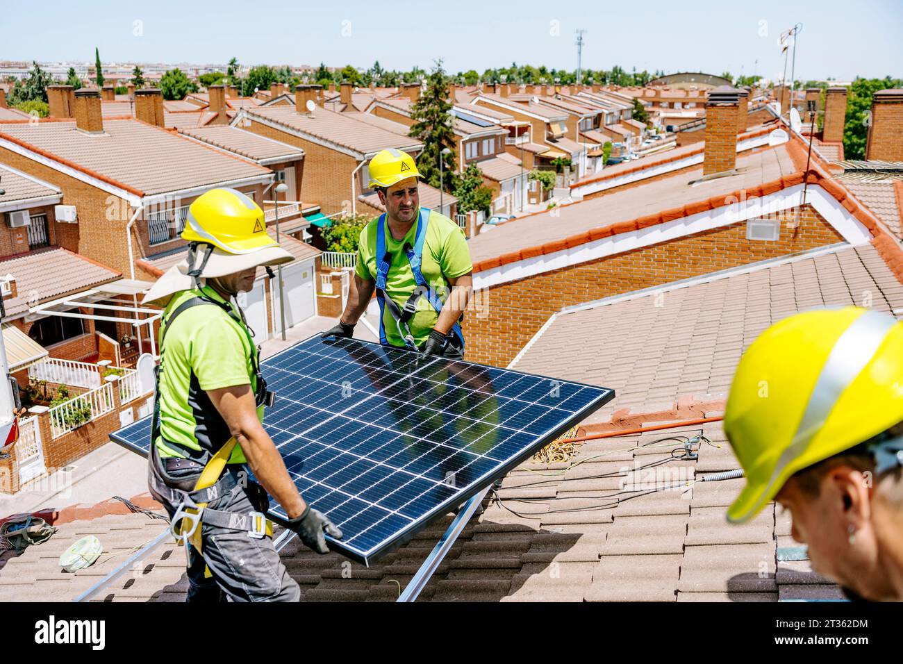 Engineers installing solar panel together on roof Stock Photo - Alamy