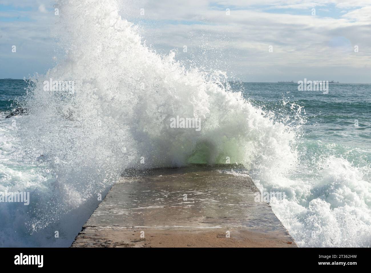 Sea waves hit the cement pier on a beach. Wild nature. Seasons Stock ...