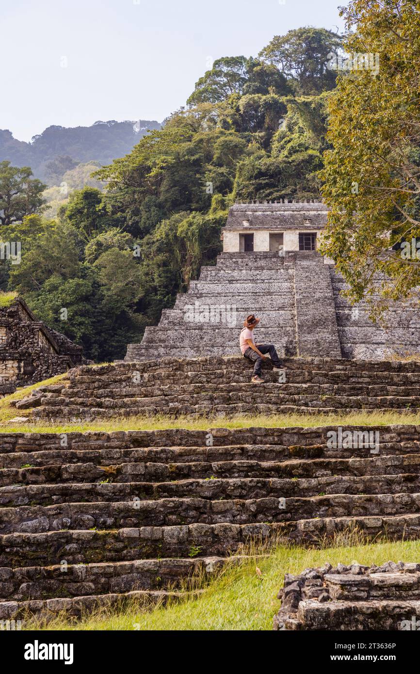 Man sitting on steps at Mayan ruins Stock Photo - Alamy