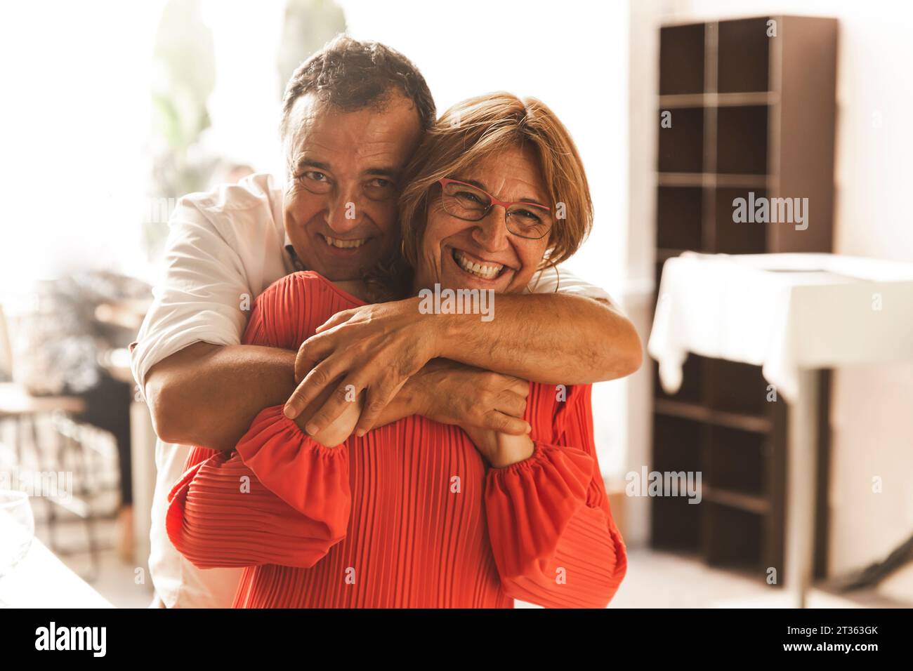 Female couple hugging home hi-res stock photography and images - Alamy