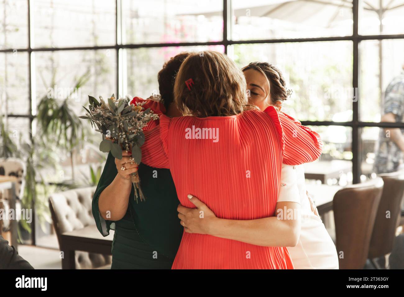 Emotional family hugging bride at wedding reception Stock Photo - Alamy
