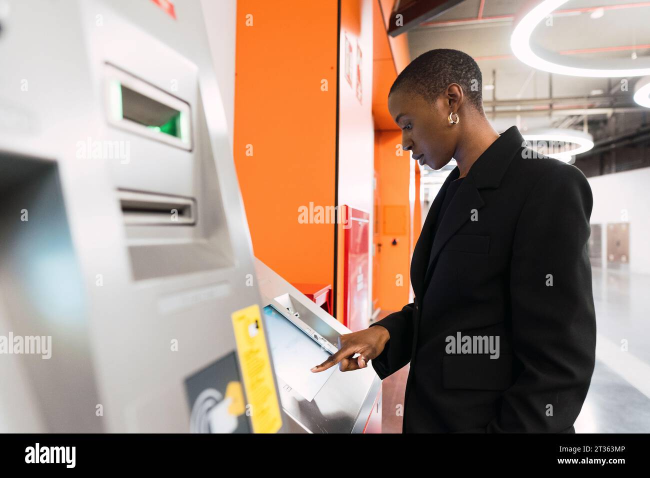 Young woman using ticket machine at underground metro station Stock ...