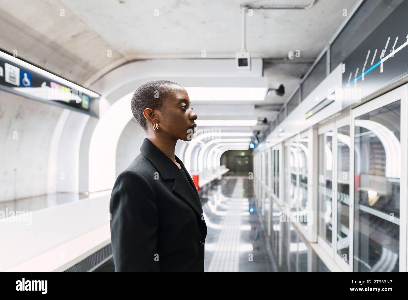 Commuter looking at metro display schedule in subway station Stock ...