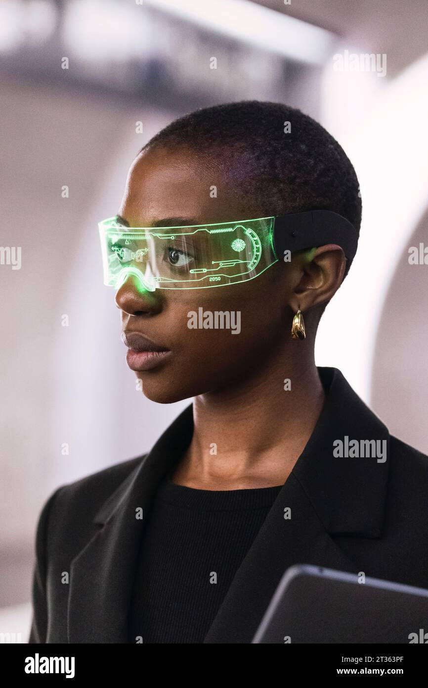 Contemplative woman wearing smart glasses Stock Photo - Alamy