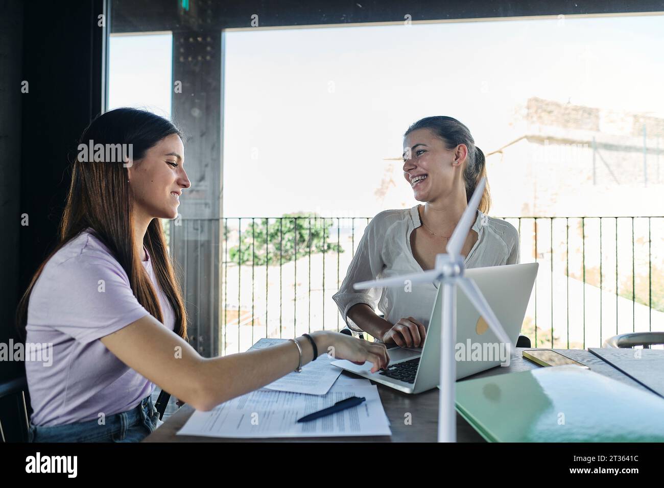 Two young female engineers working together at cowrking space Stock ...