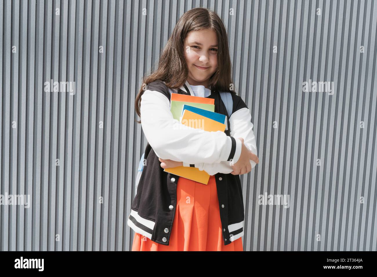 School girl in uniform with books hi-res stock photography and images ...