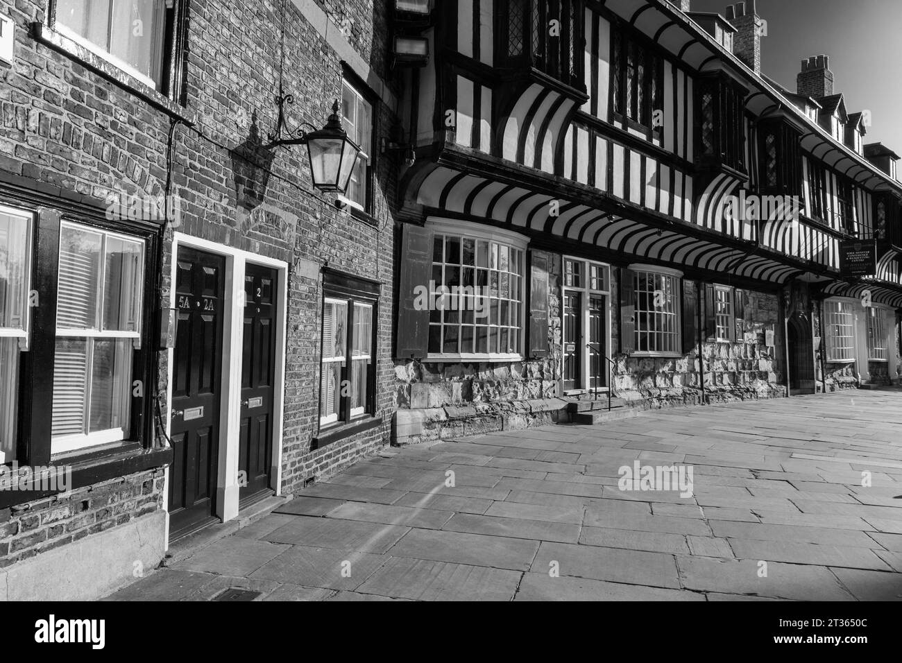 Red brick and half timbered properties that make up Minster Yard, York ...