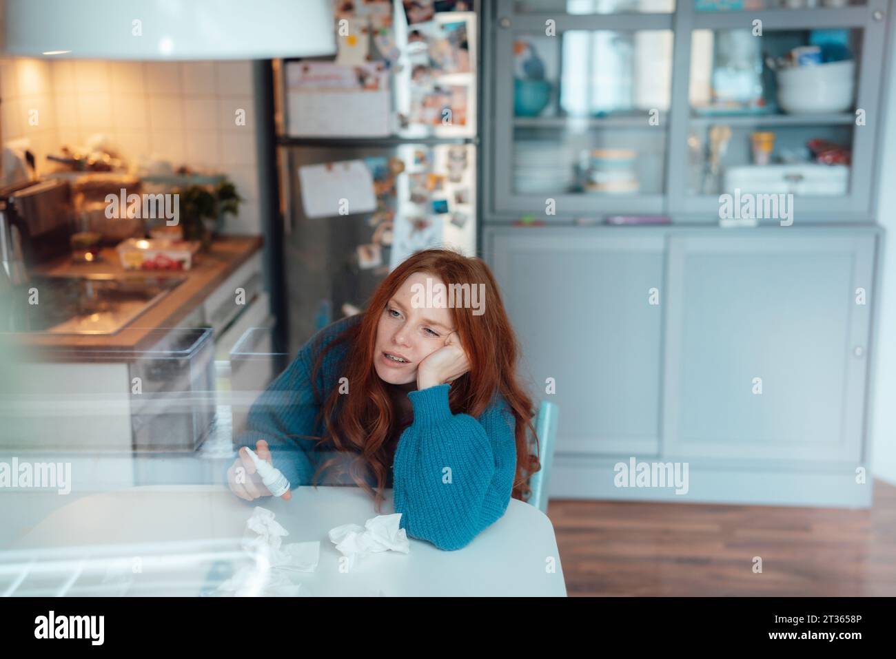 Sick woman sitting with medicine at table Stock Photo - Alamy